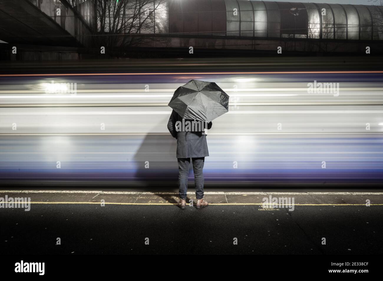 man standing on a platform Stock Photo - Alamy