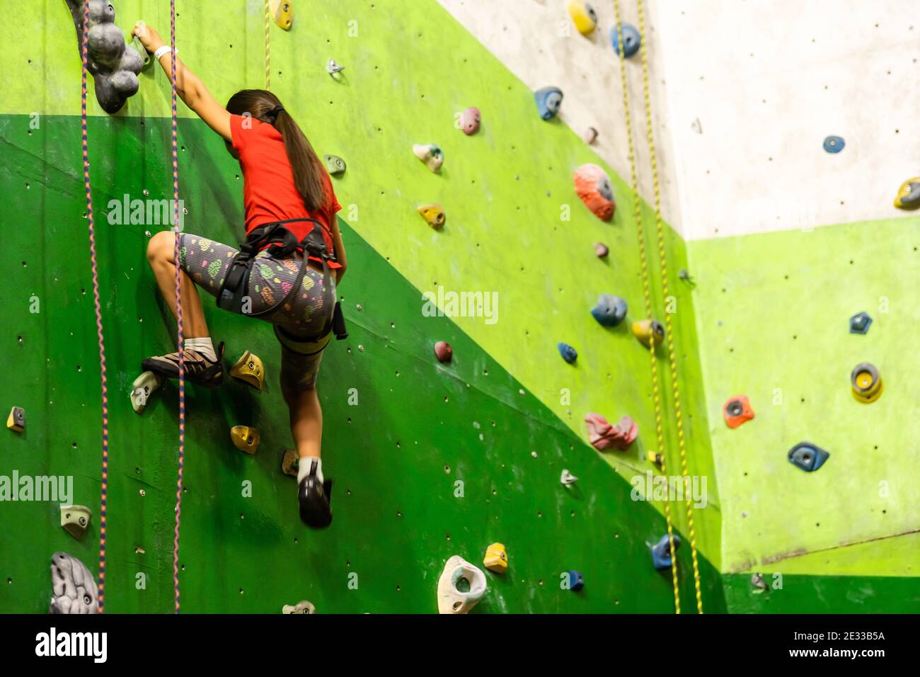 Little Girl Climbing Rock Wall Stock Photo - Alamy