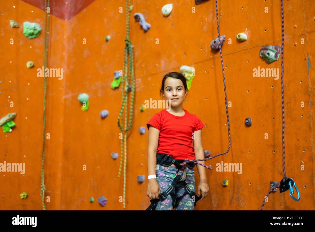 Little Girl Climbing Rock Wall practical wall in gym Stock Photo - Alamy