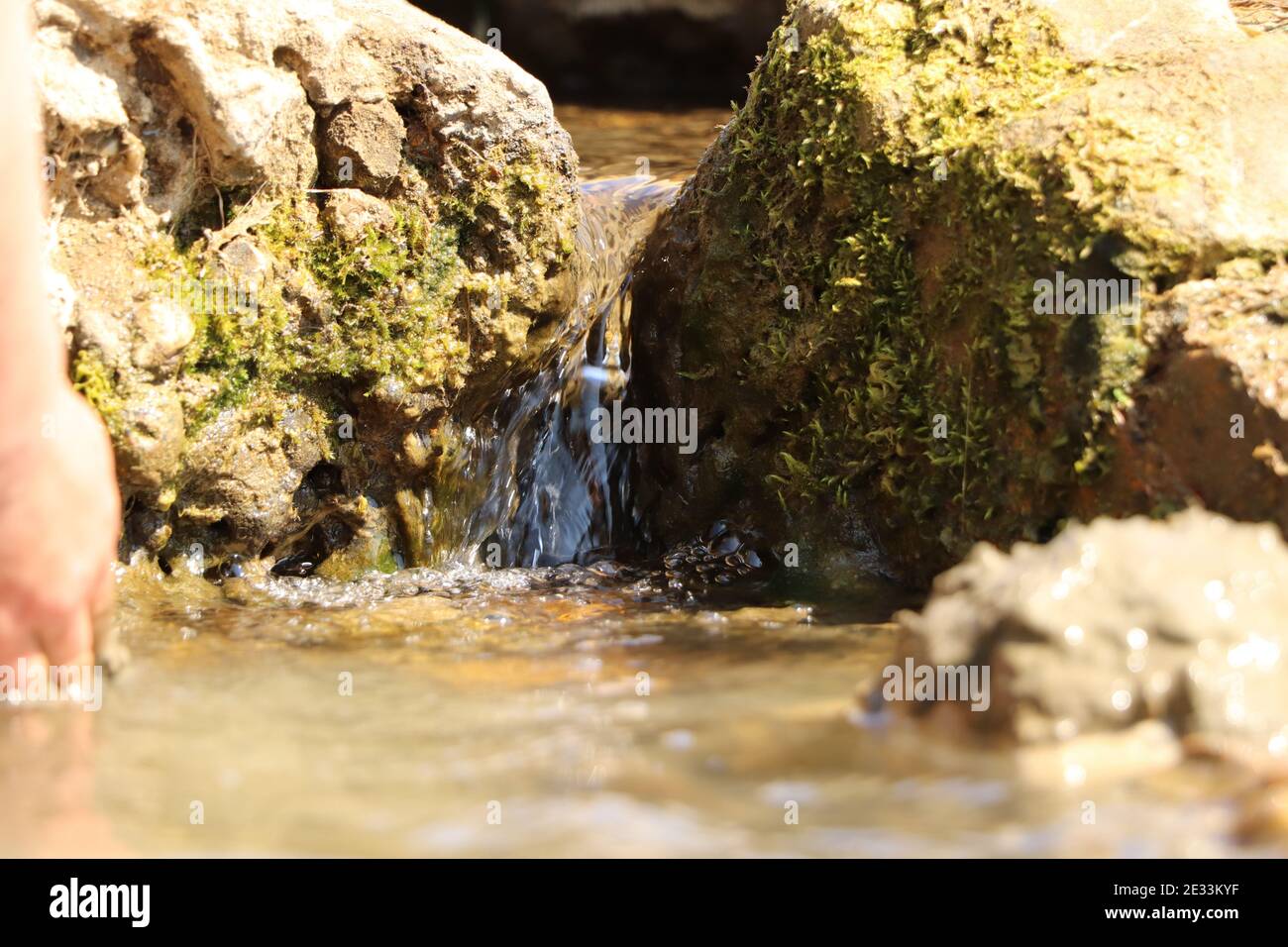 Ground level close up of mud and water sloshing down a stream Stock ...
