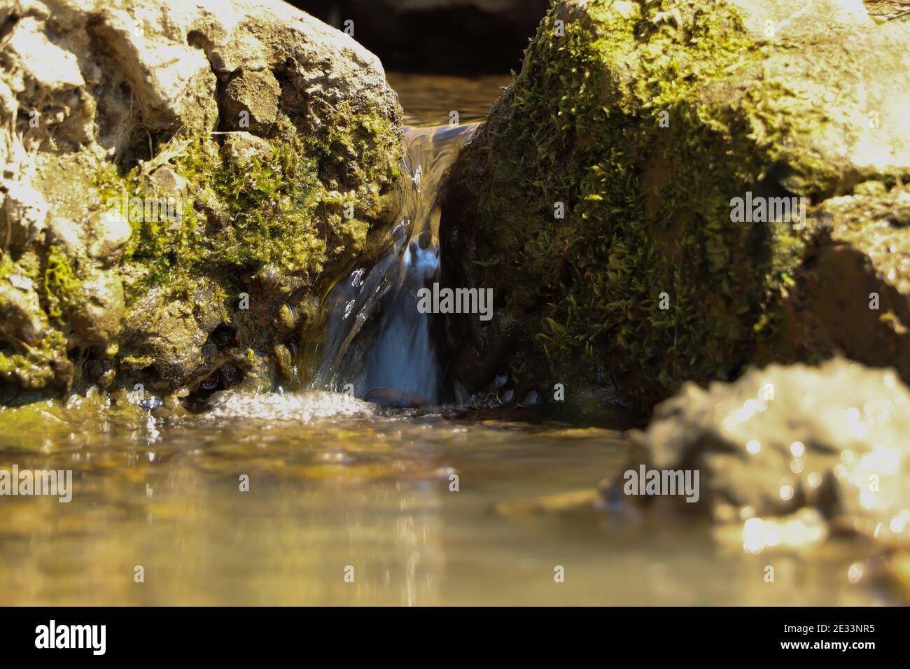 Ground level close up of mud and water sloshing down a stream Stock ...