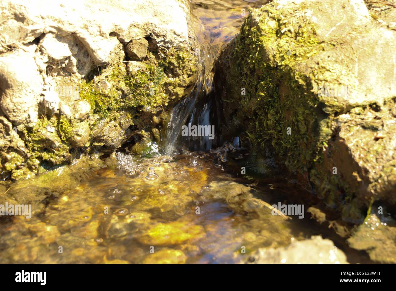 Ground level close up of mud and water sloshing down a stream Stock ...