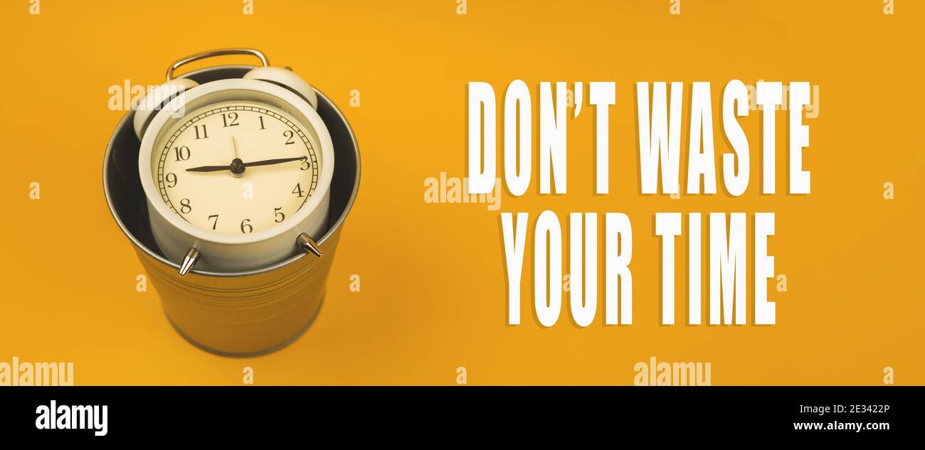 Don't waste your time concept with alarm clock and trash bin, banner on ...