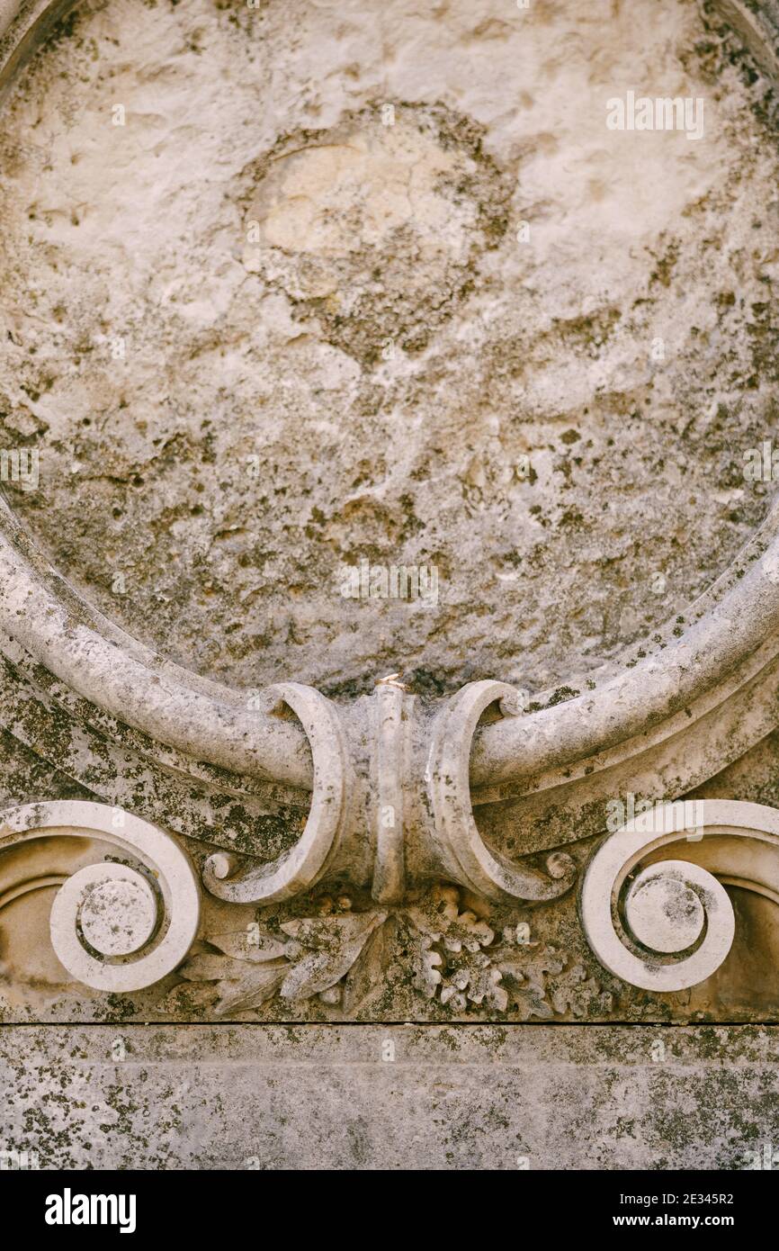 Close-up of gray stone bas-relief texture with gold rings of the bride ...