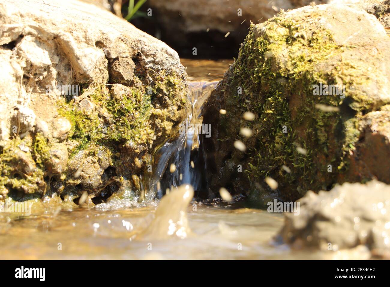 Ground level close up of mud and water sloshing down a stream Stock ...