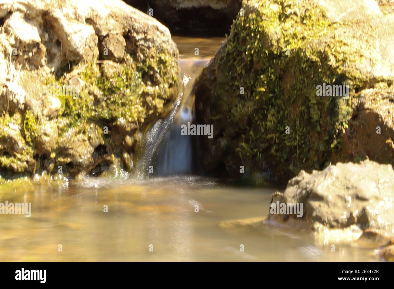 Ground level close up of mud and water sloshing down a stream Stock ...