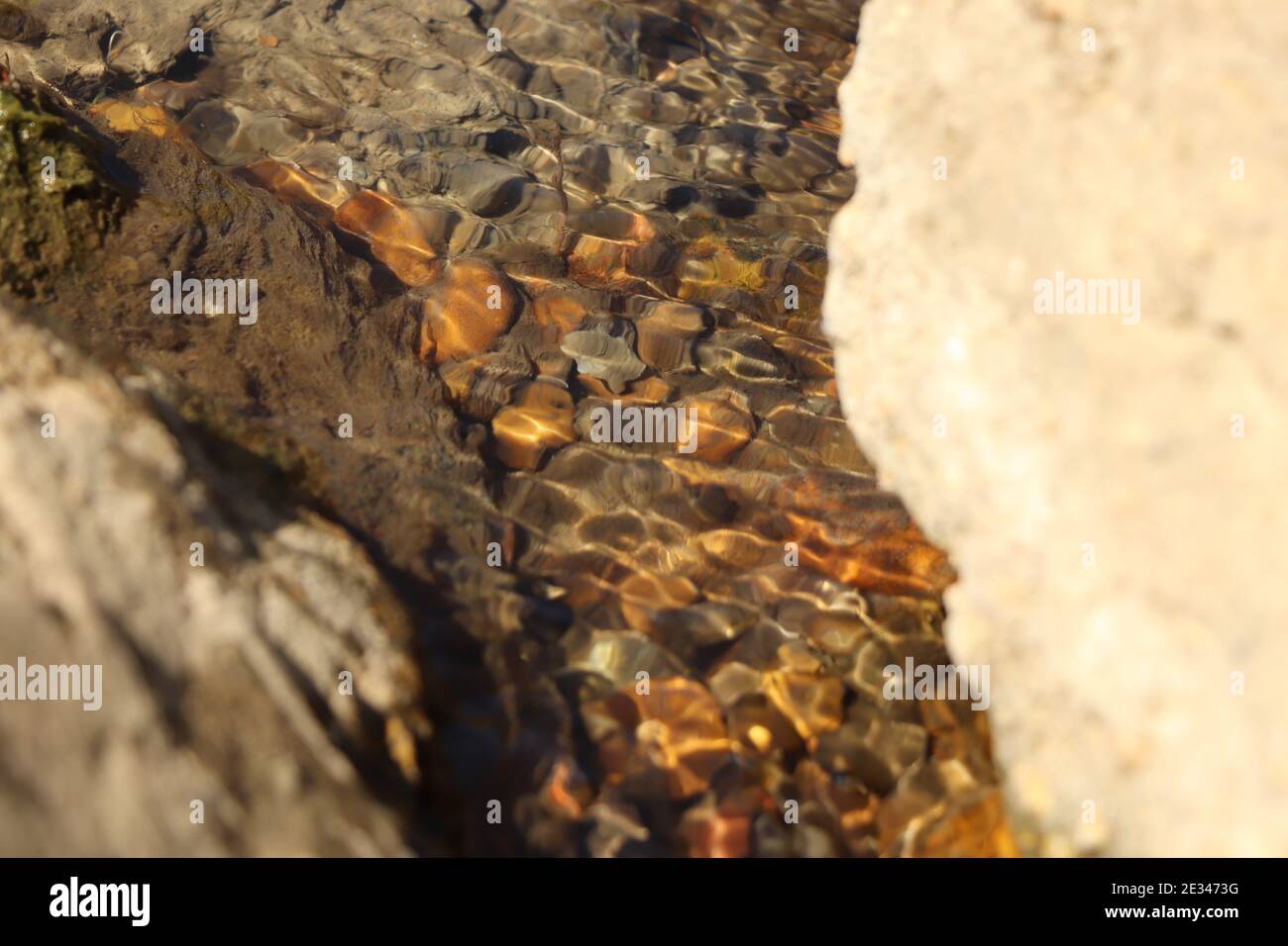 Ground level close up of mud and water sloshing down a stream Stock ...
