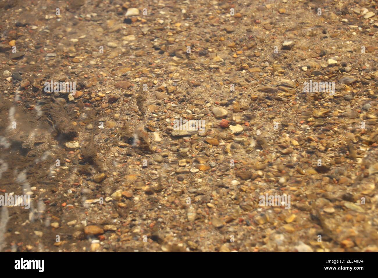 Ground level close up of mud and water sloshing down a stream Stock ...
