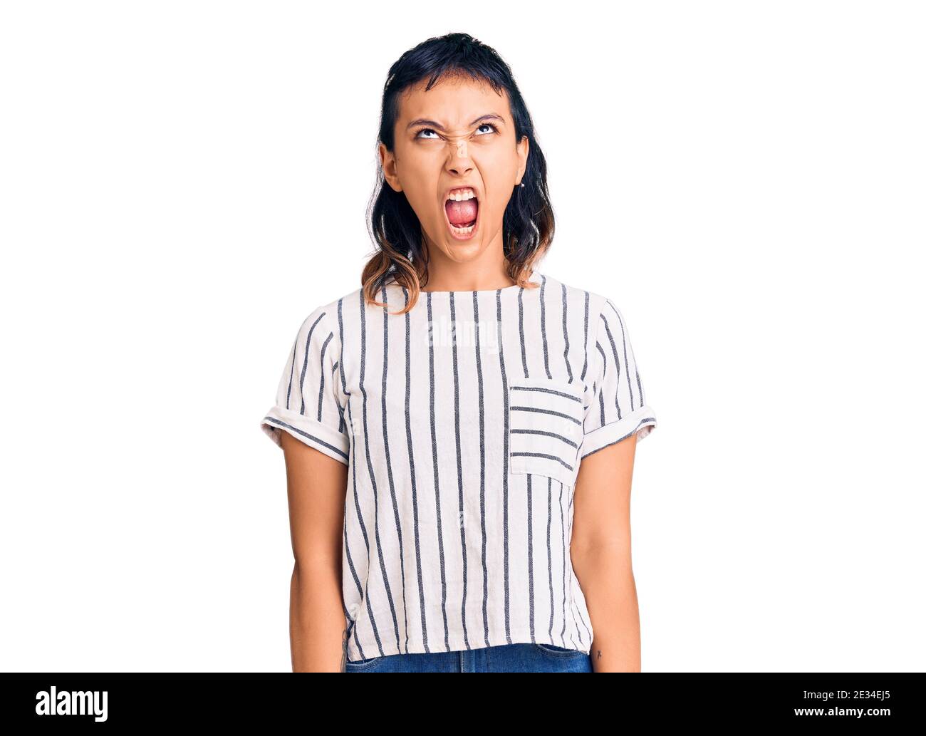 Young woman wearing casual clothes angry and mad screaming frustrated ...