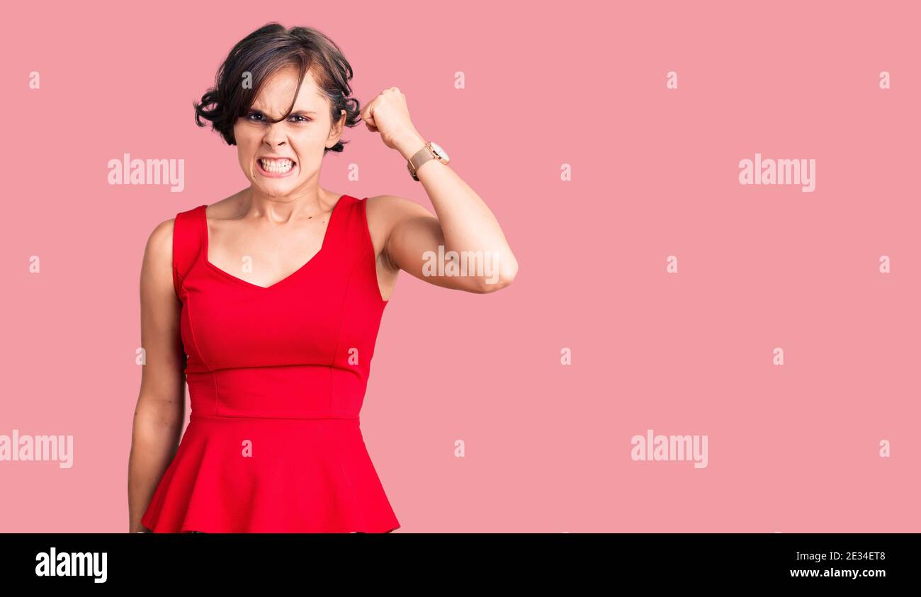 Beautiful young woman with short hair wearing casual style with ...