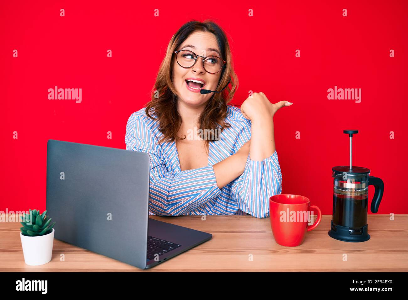 Young beautiful caucasian woman working at the office wearing operator ...