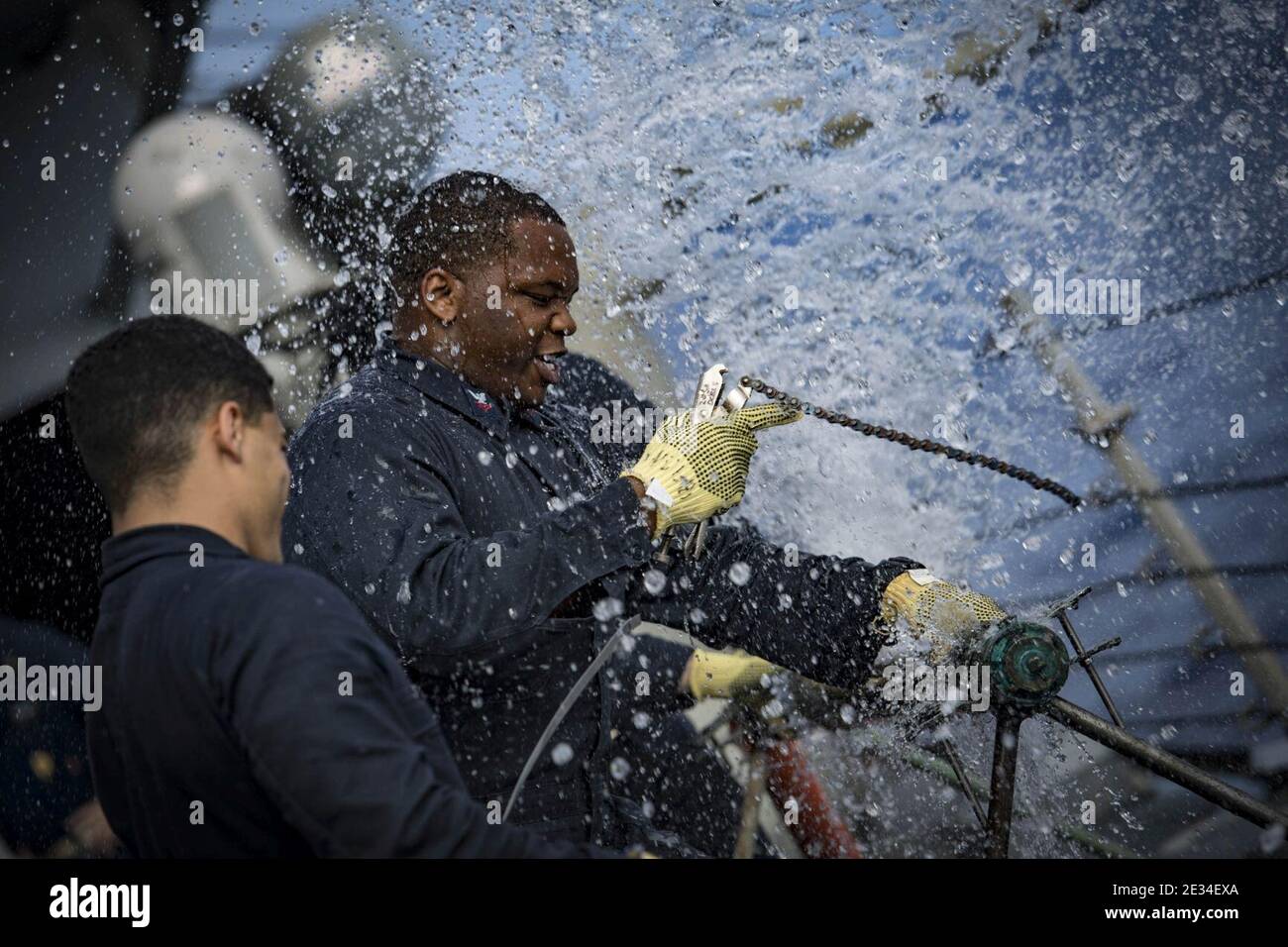 Machinist's Mate patching simulated ruptured pipe during damage control ...
