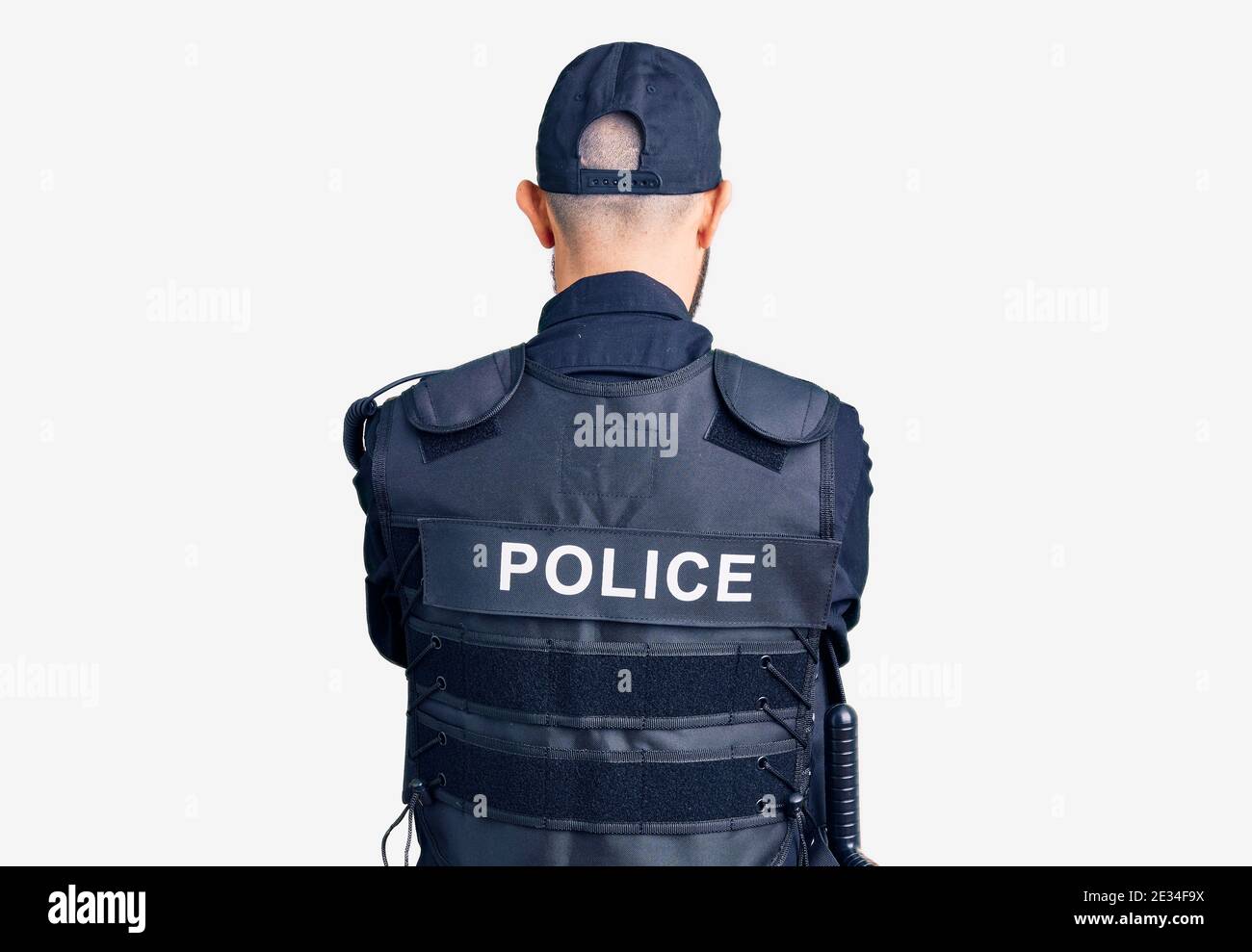 Young handsome man wearing police uniform standing backwards looking ...