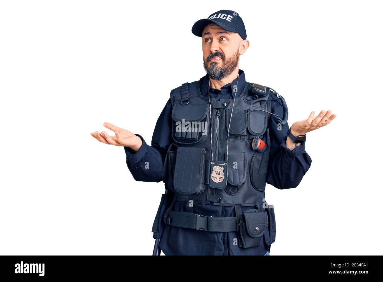 Young handsome man wearing police uniform clueless and confused with ...