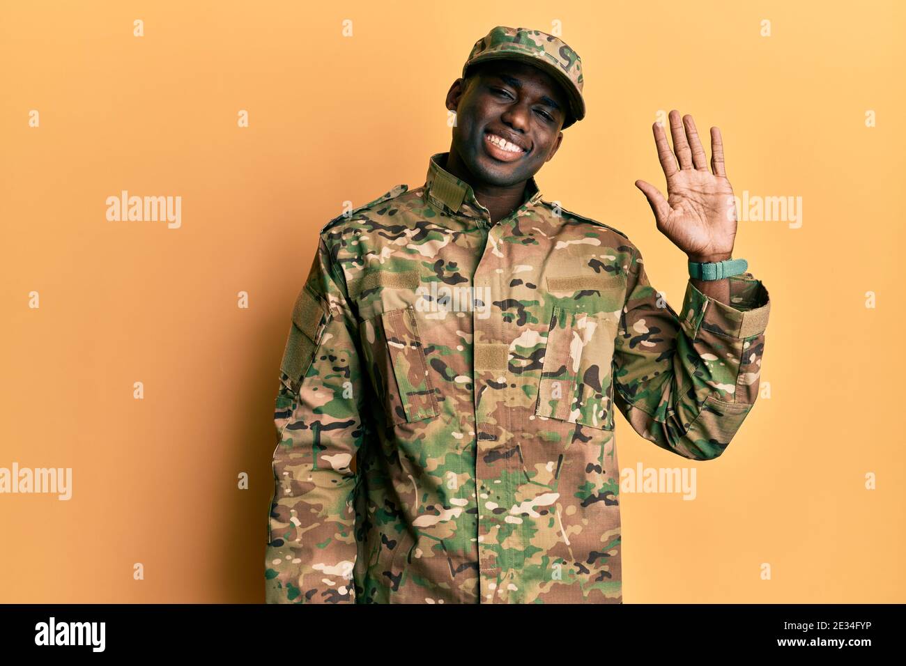 Young african american man wearing army uniform waiving saying hello ...
