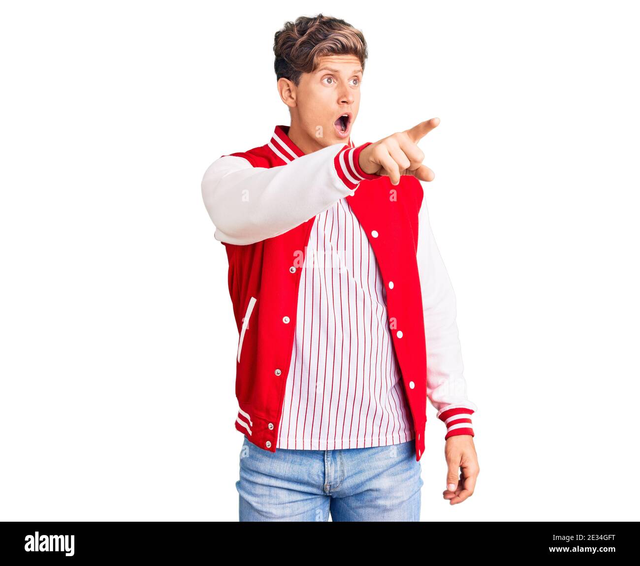 Young handsome man wearing baseball uniform pointing with finger ...