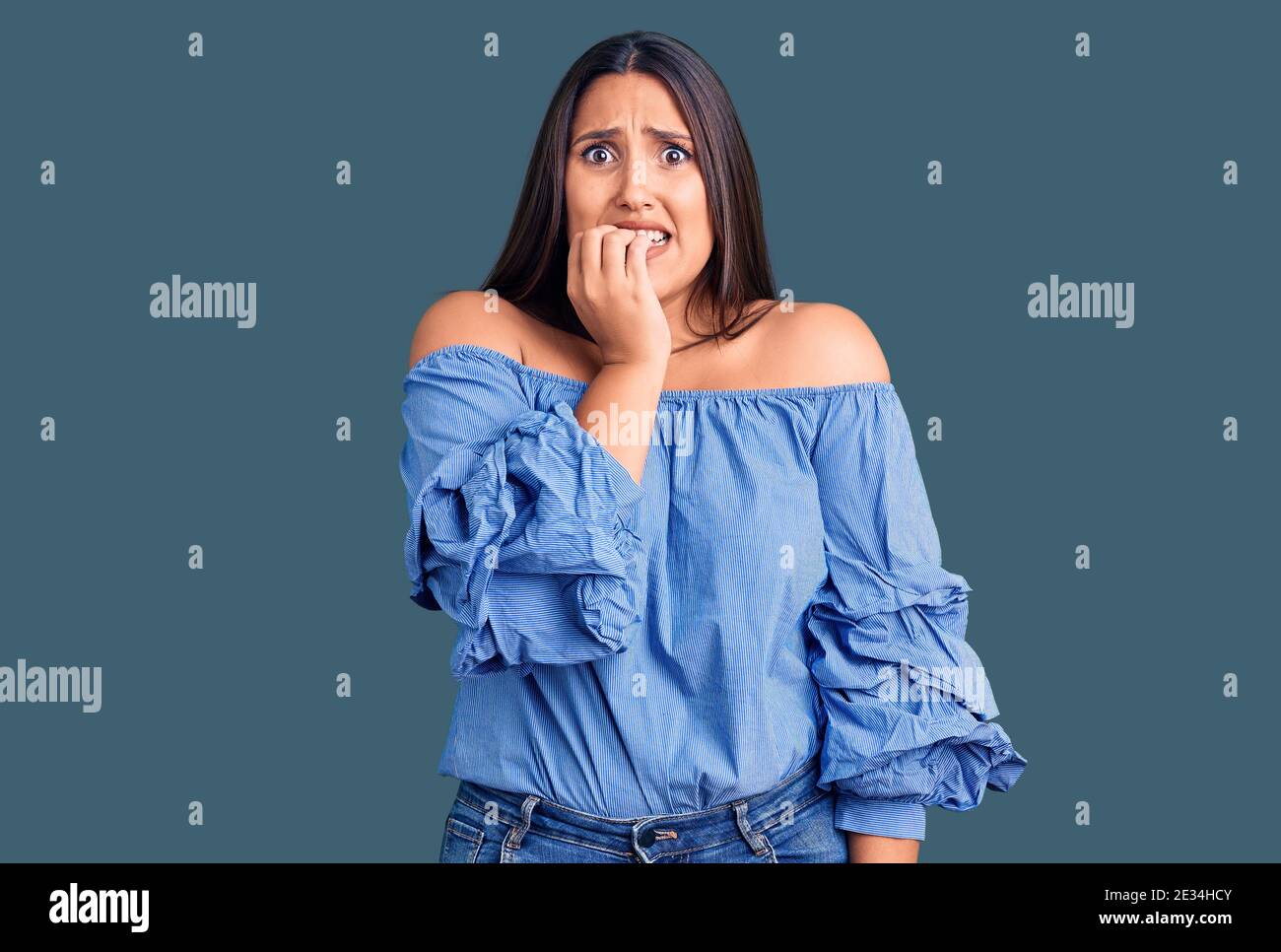 Young beautiful brunette woman wearing casual t-shirt looking stressed ...