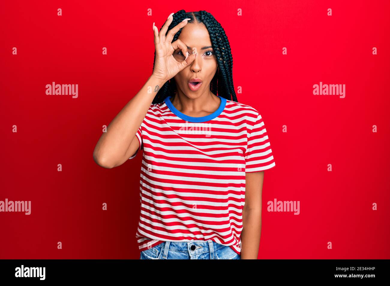 Beautiful hispanic woman wearing casual clothes doing ok gesture ...