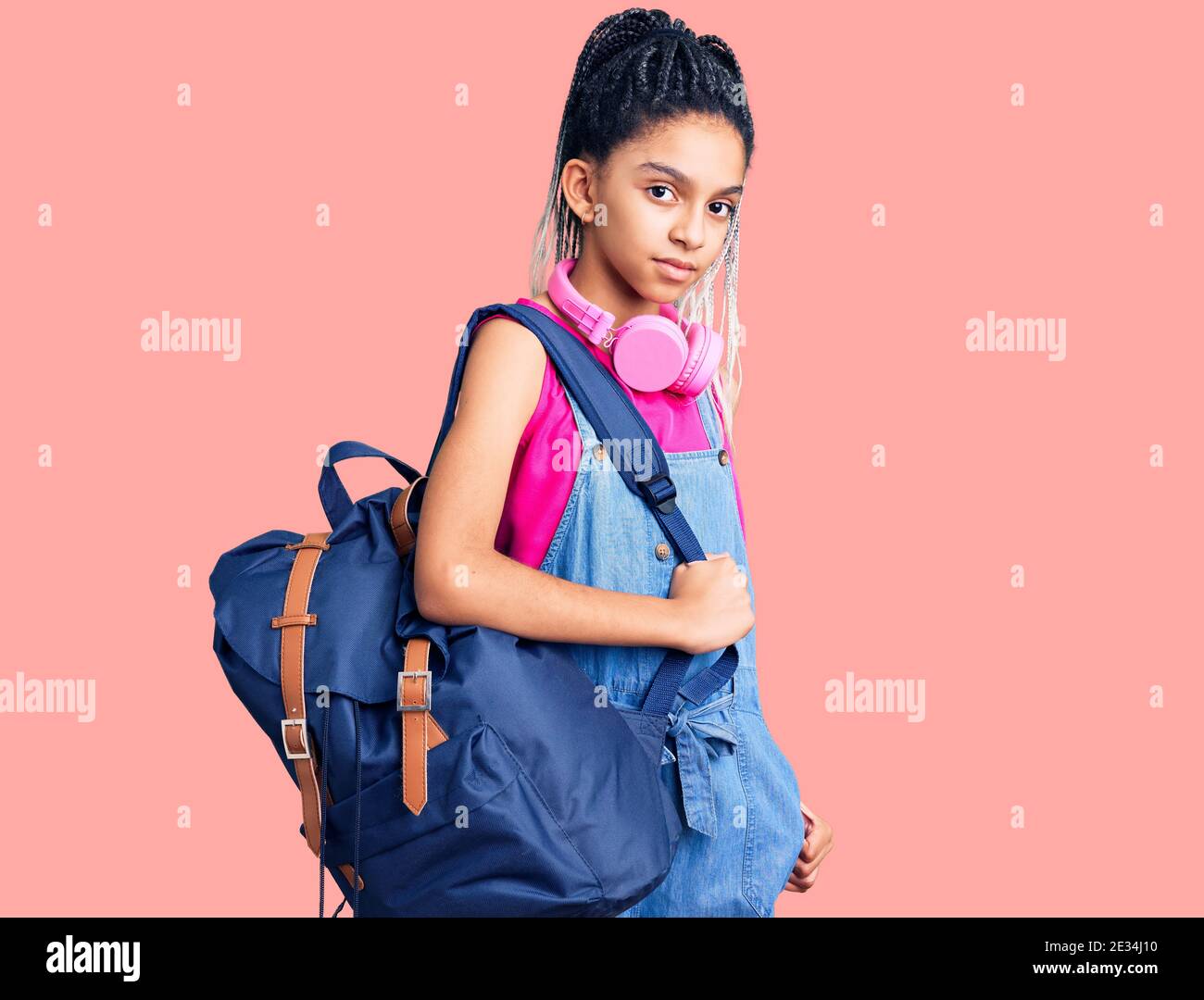 Cute african american girl holding student backpack using backpack ...