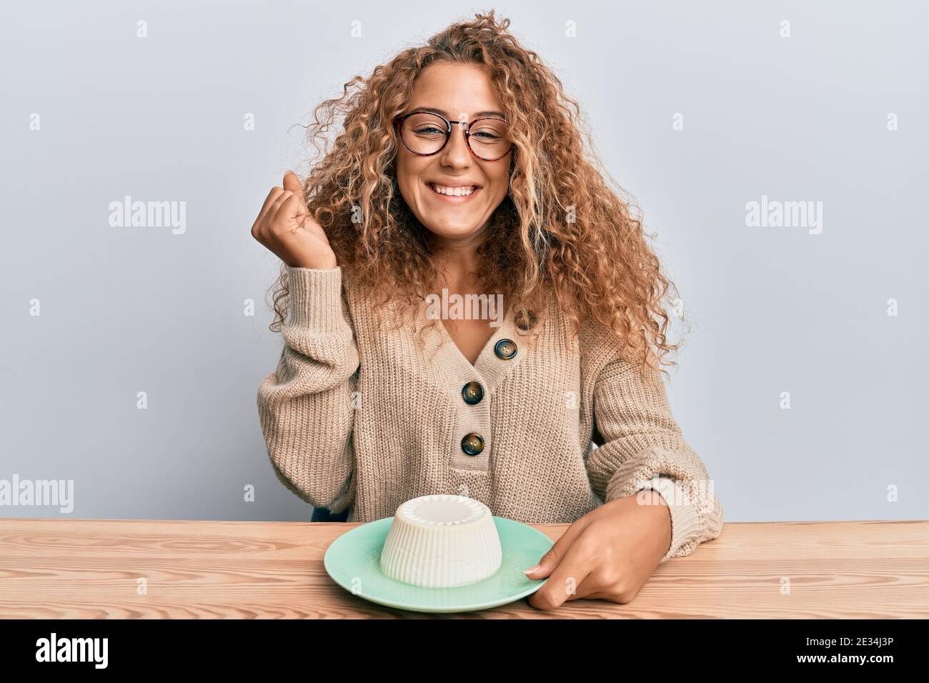 Beautiful caucasian teenager girl eating fresh white cheese screaming ...