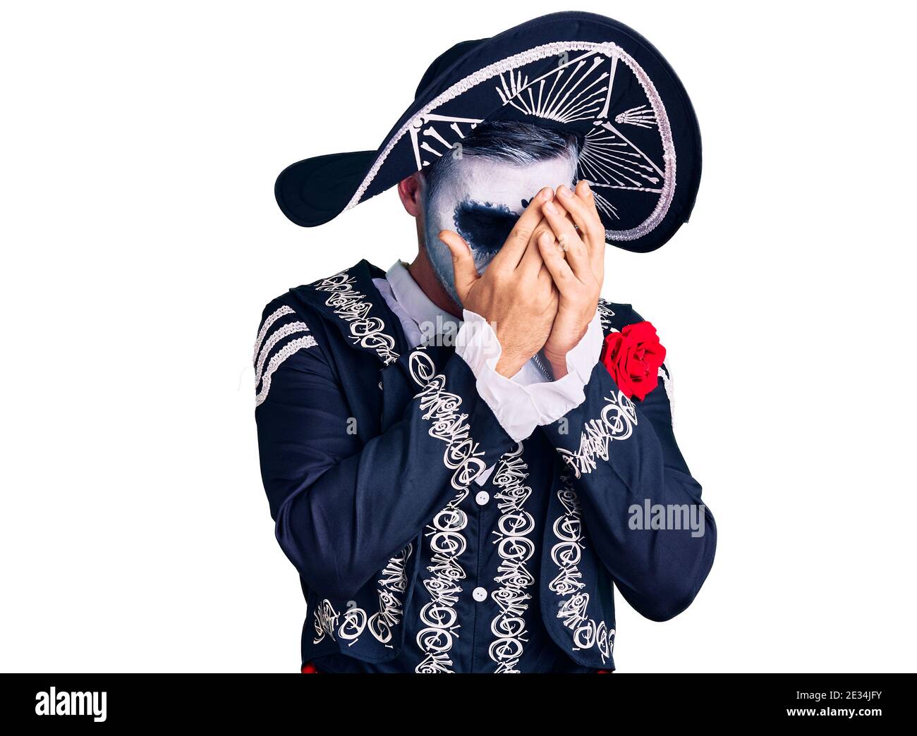 Young man wearing day of the dead costume over background with sad ...