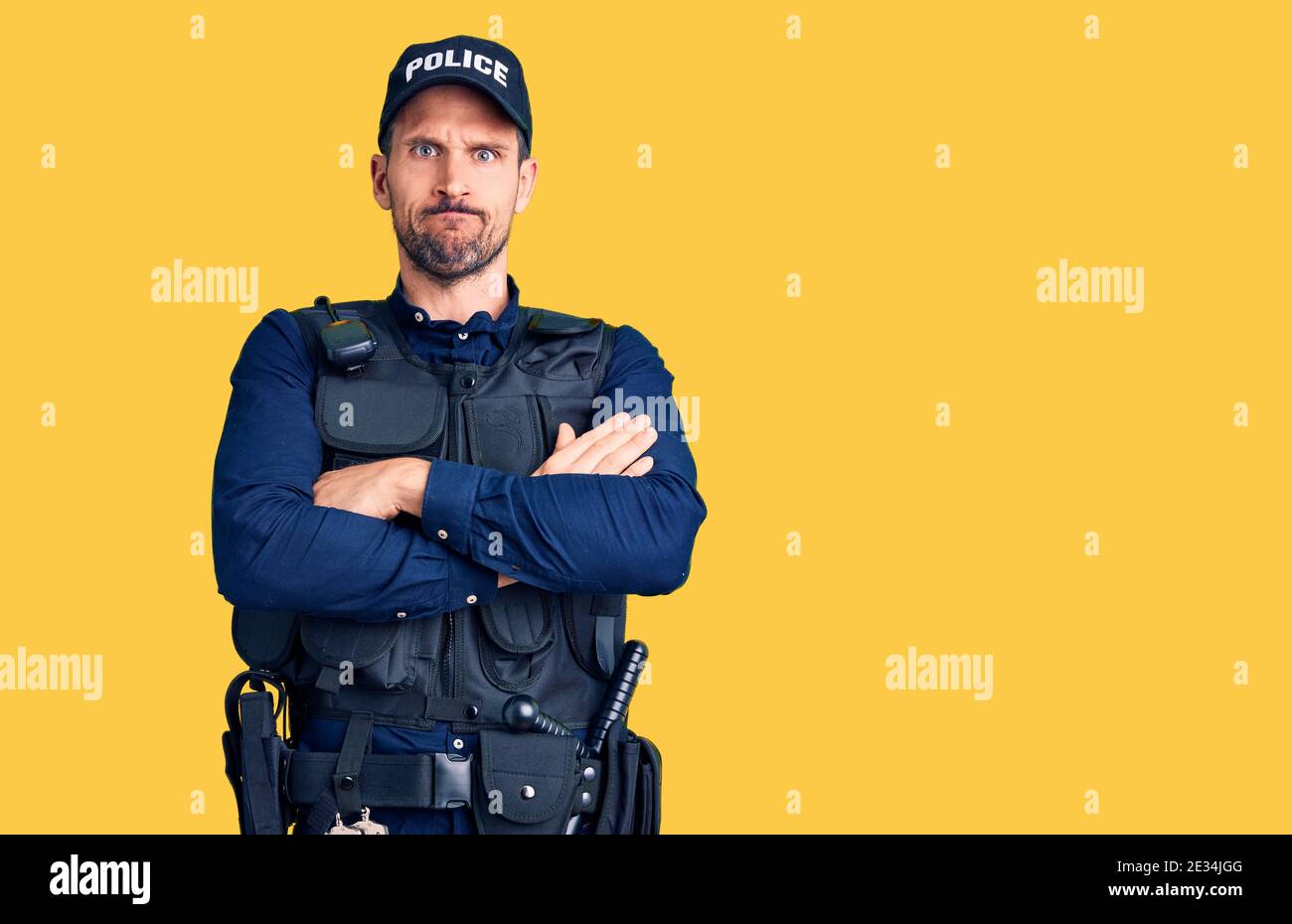 Young handsome man wearing police uniform skeptic and nervous ...