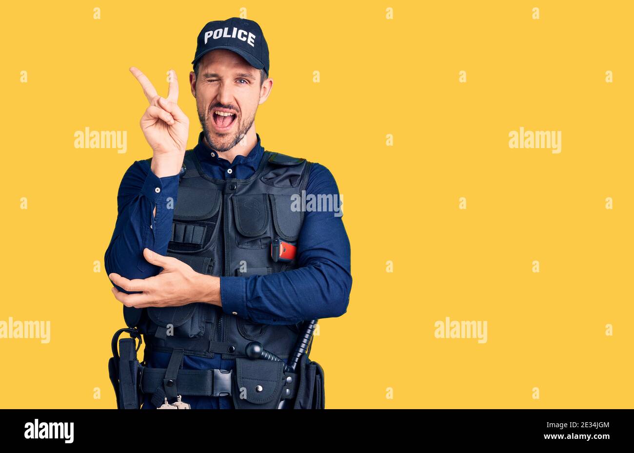 Young handsome man wearing police uniform smiling with happy face ...