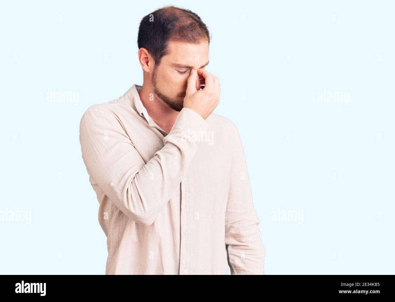 Young handsome caucasian man wearing casual clothes tired rubbing nose ...