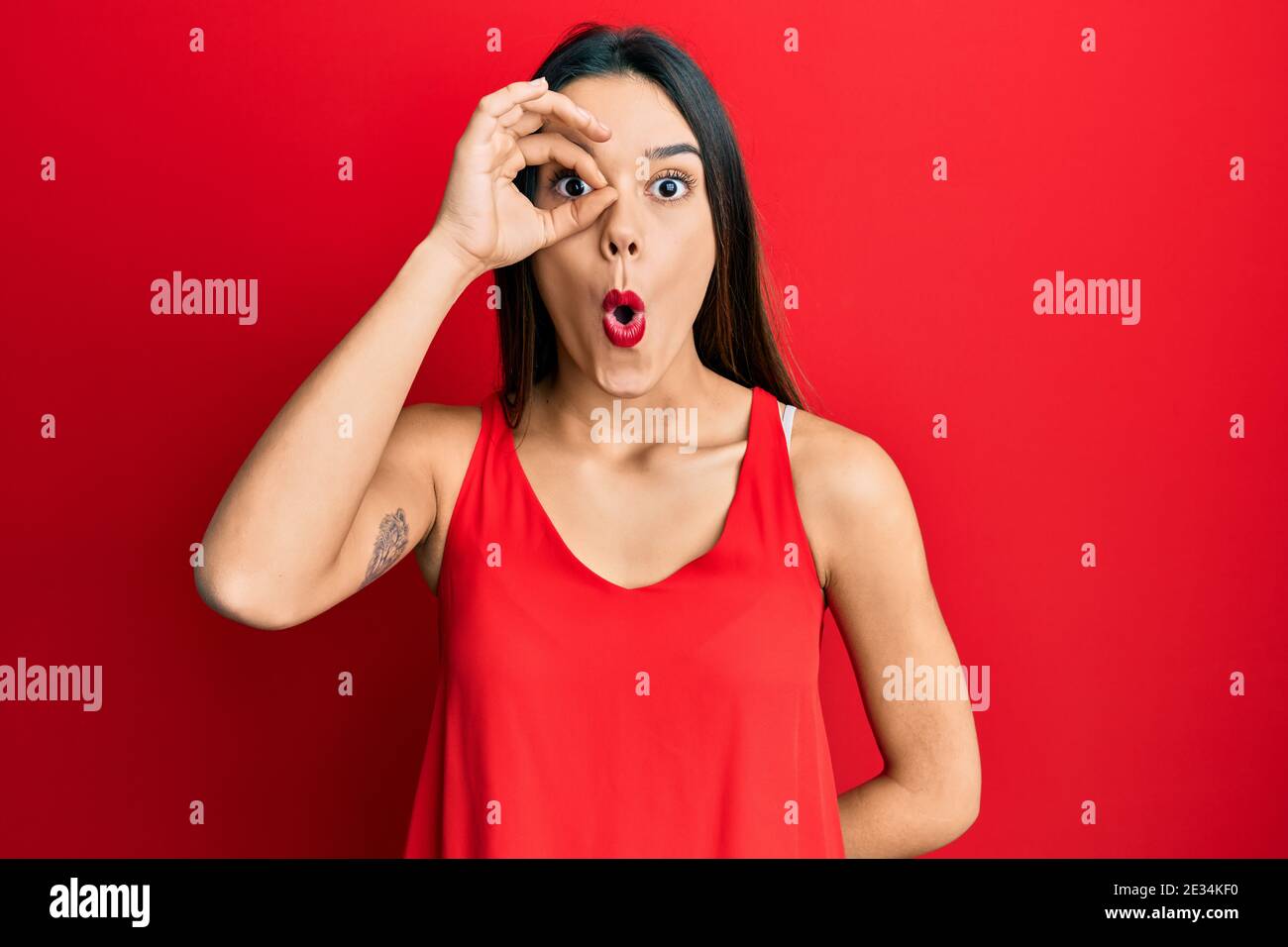 Young hispanic girl wearing casual style with sleeveless shirt doing ok ...