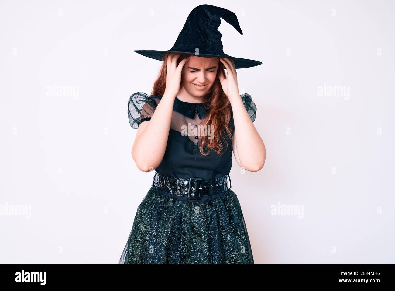 Young beautiful woman wearing witch halloween costume suffering from ...