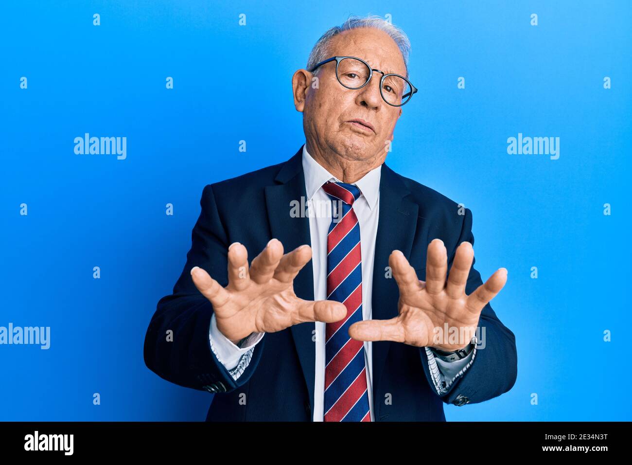 Senior caucasian man wearing business suit and tie moving away hands ...