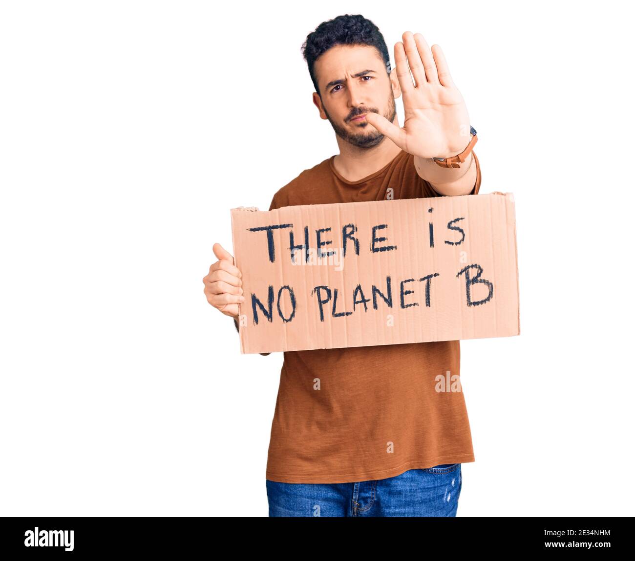 Young hispanic man holding there is no planet b banner with open hand ...