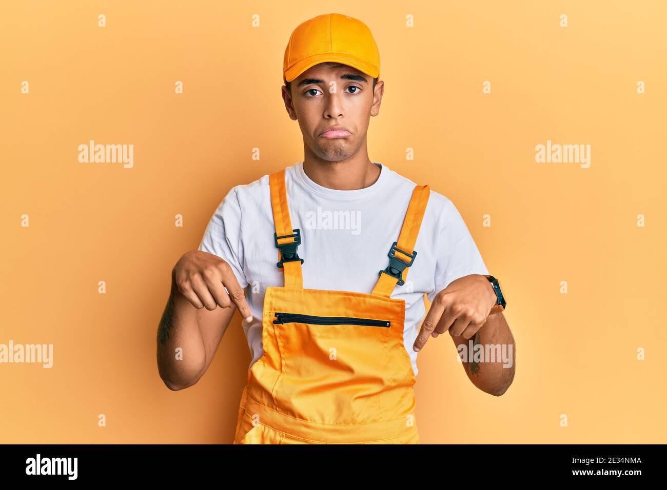 Young handsome african american man wearing handyman uniform over ...