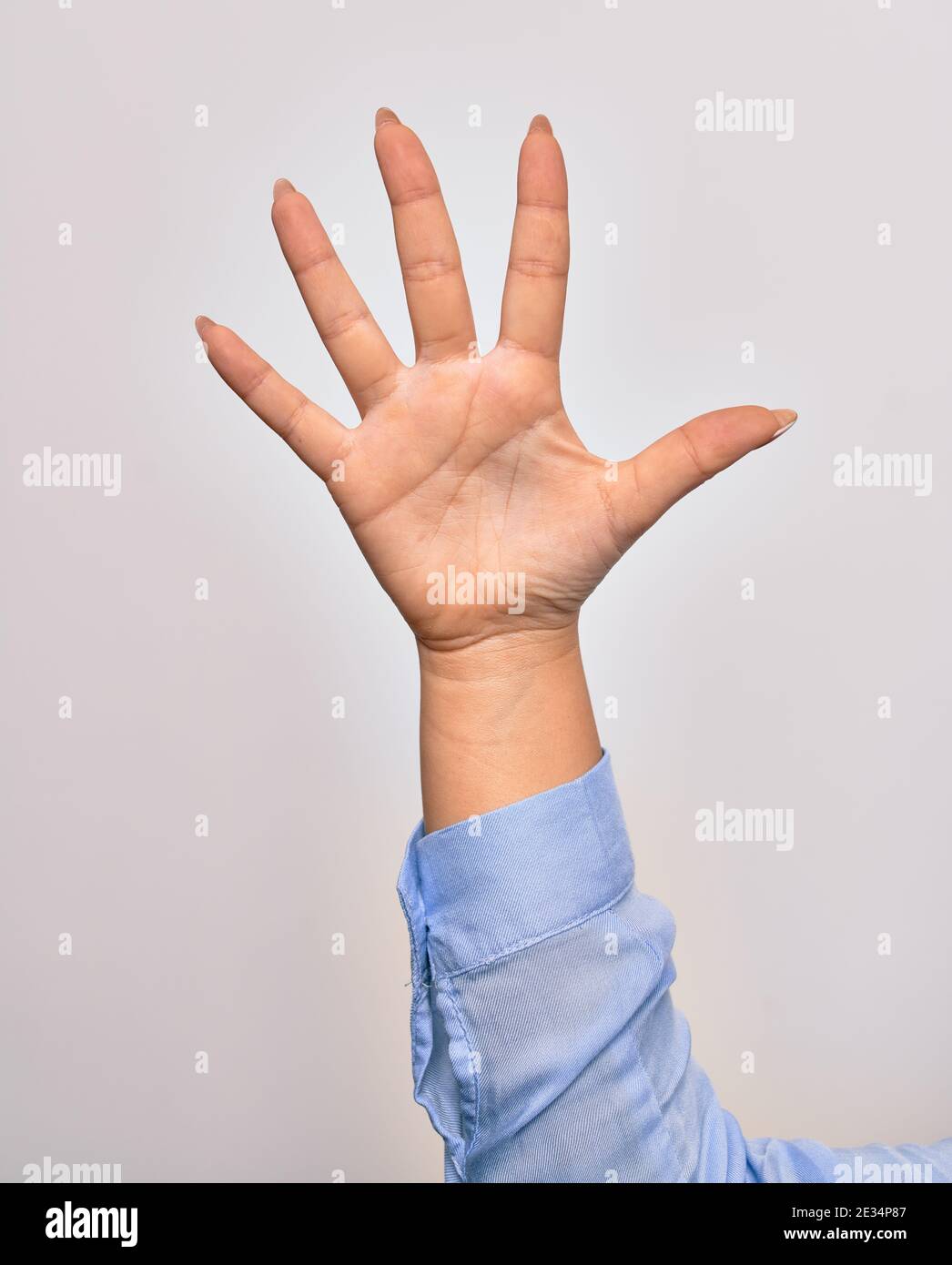 Hand of caucasian young woman showing number five with opened palm and ...
