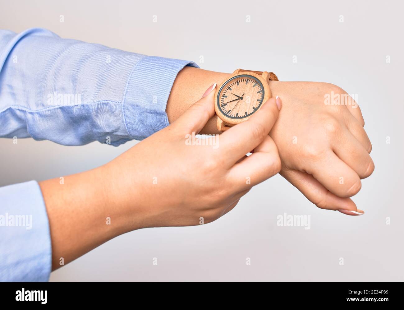 Hand of caucasian young businesswoman wearing wristwatch. Catching ...
