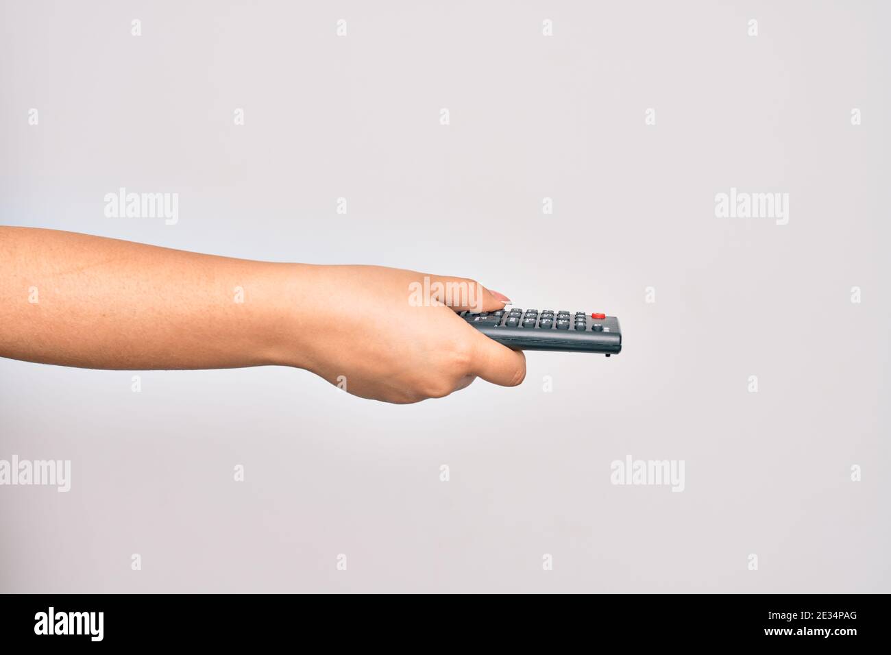 Hand of caucasian young woman changing television channel holding tv ...