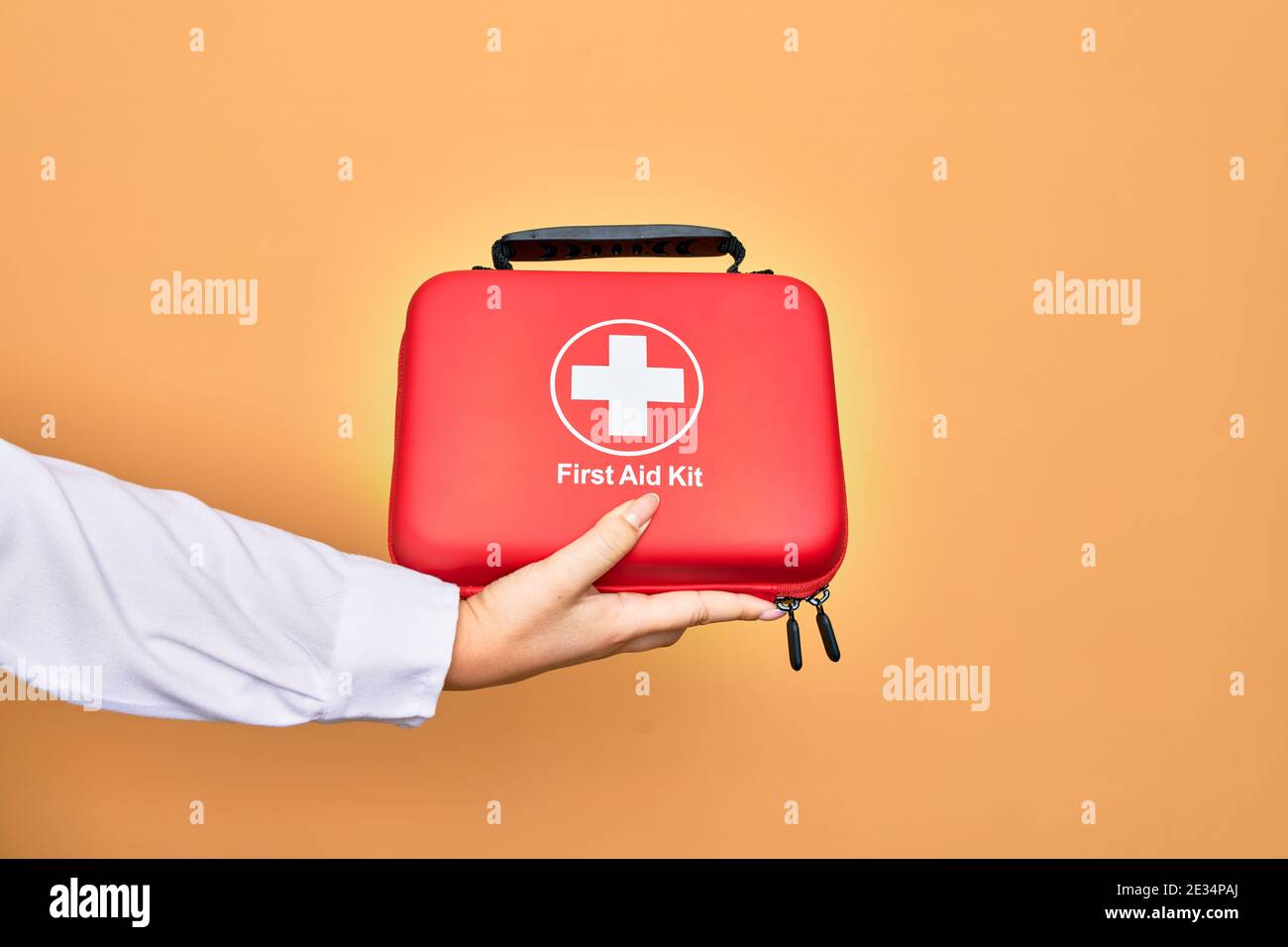 Hand of caucasian young woman holding first aid kit briefcase over ...
