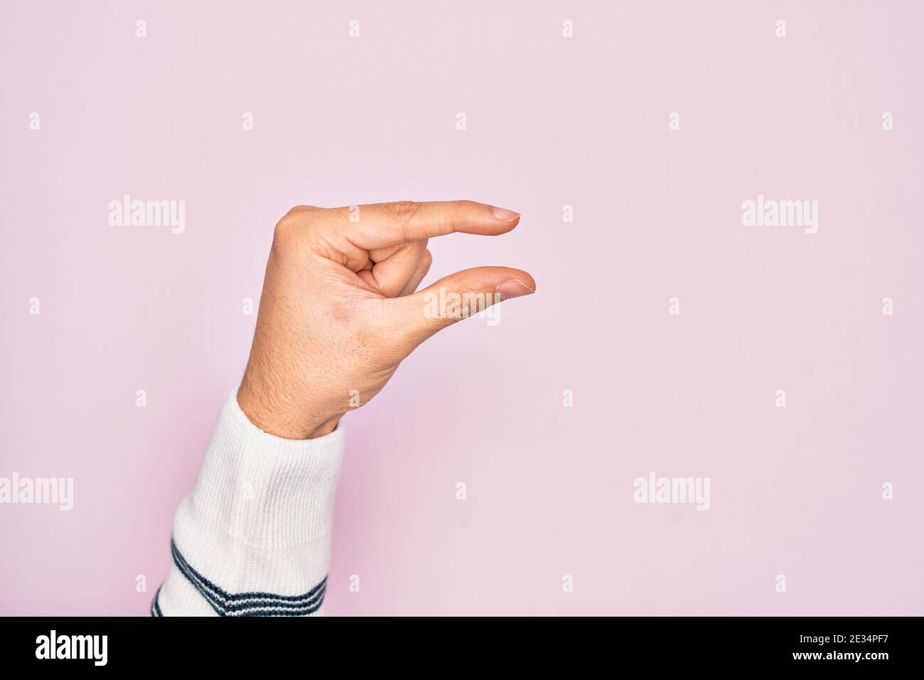 Hand of caucasian young man showing fingers over isolated pink ...