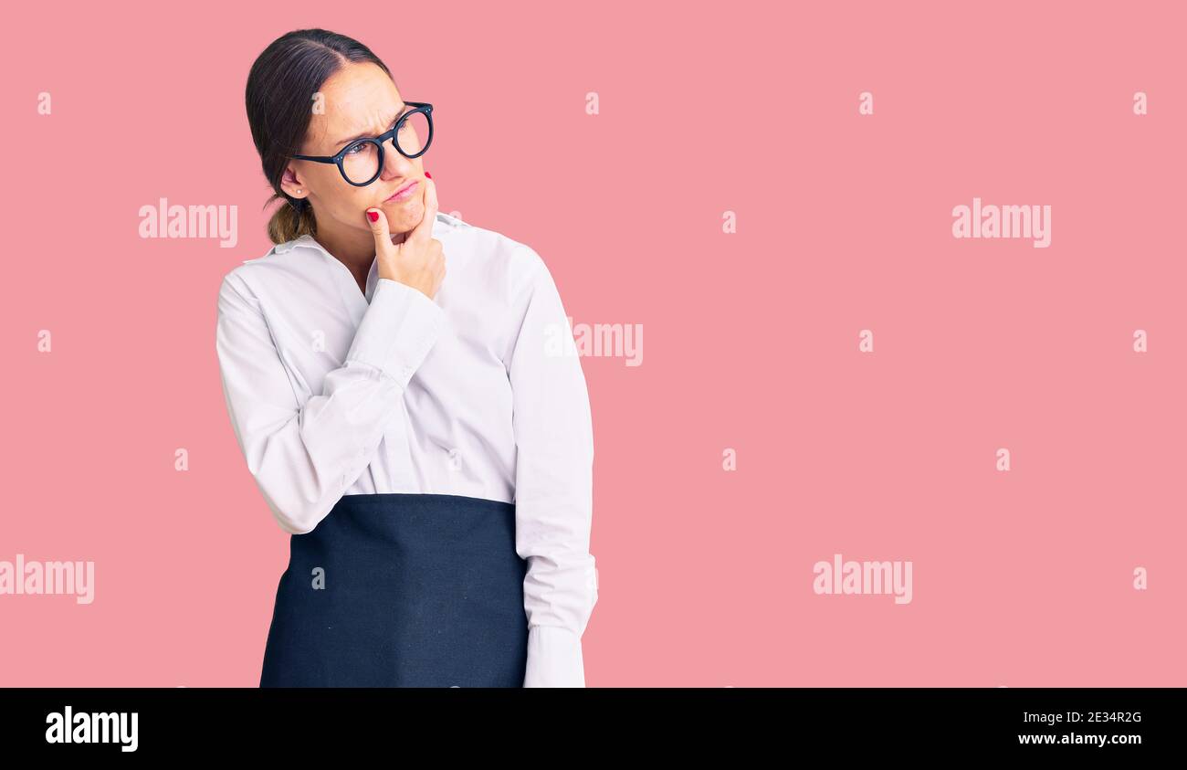 Beautiful brunette young woman wearing professional waitress apron ...