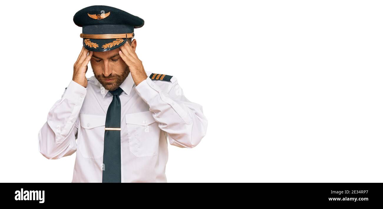 Handsome man with beard wearing airplane pilot uniform with hand on ...