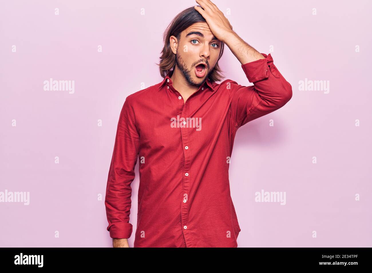 Young handsome man wearing business clothes surprised with hand on head for mistake, remember ...