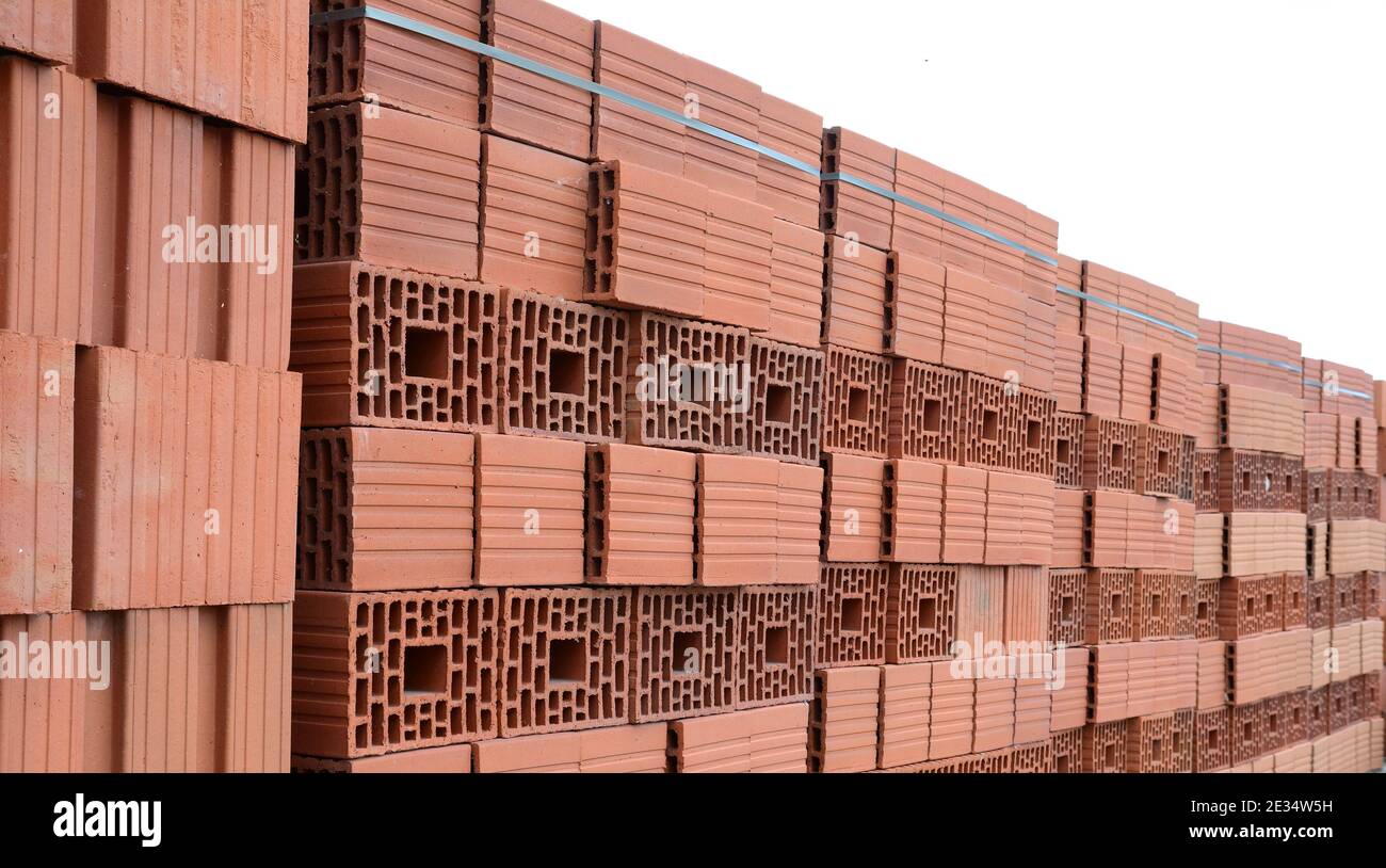 Wall blocks made from red porous ceramics with rectangular holes on a ...