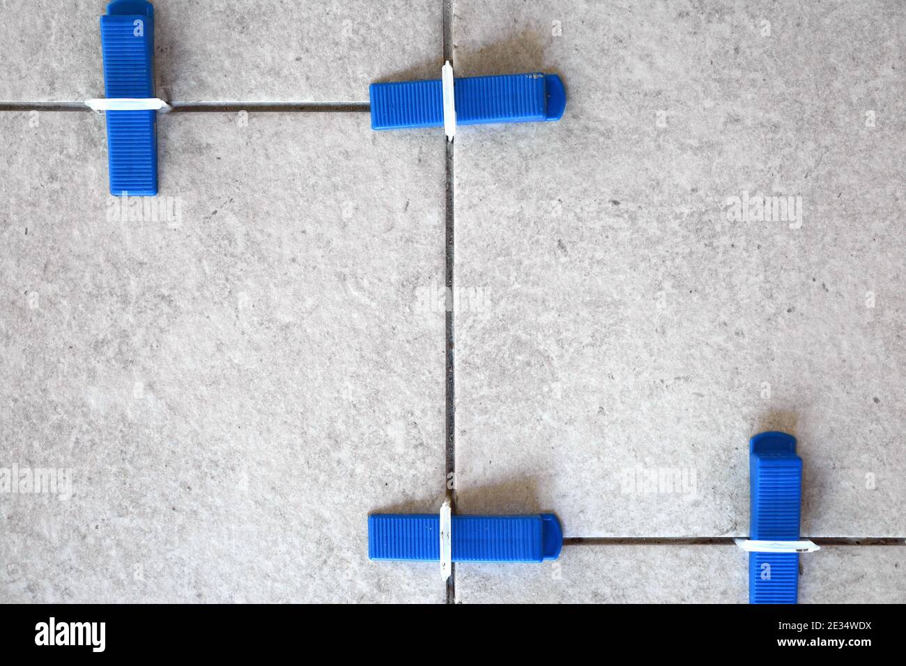 Industrial background. Tile leveling system with plastic clips and ...