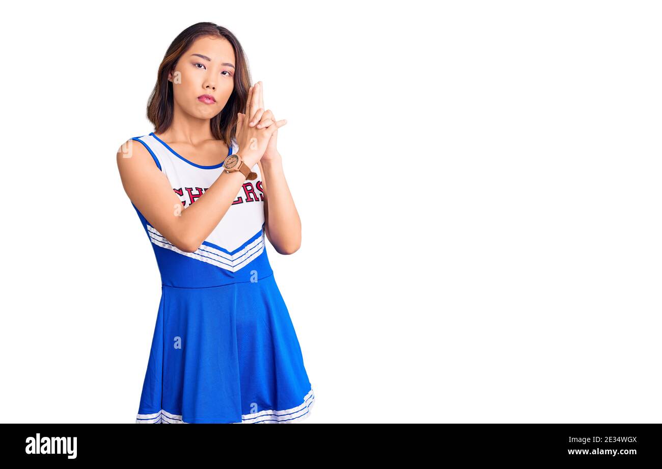 Young Beautiful Chinese Girl Wearing Cheerleader Uniform Holding