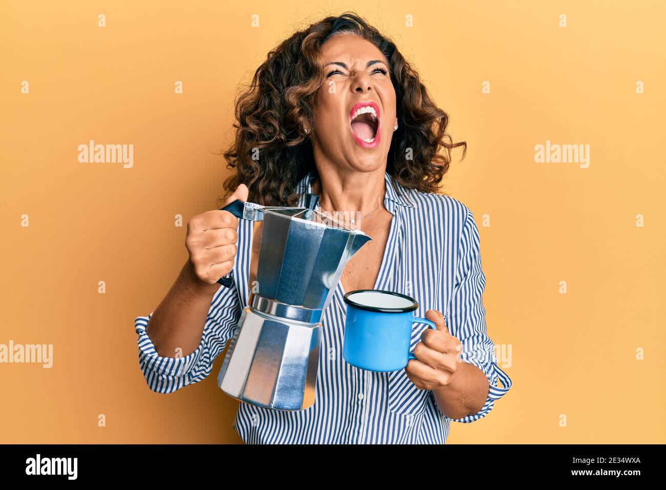 Middle age hispanic woman drinking italian coffee angry and mad ...