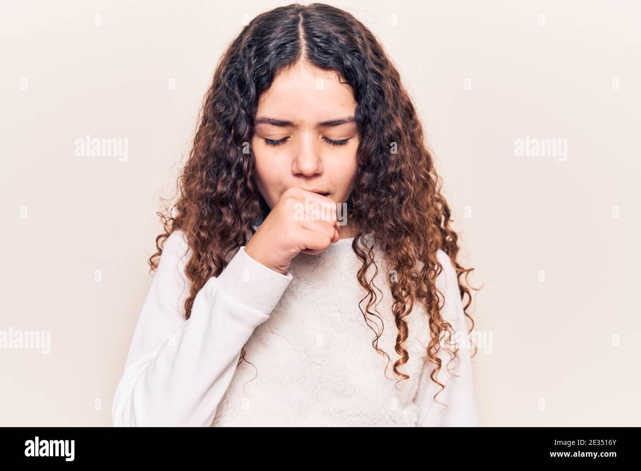 Beautiful kid girl with curly hair wearing casual clothes feeling ...