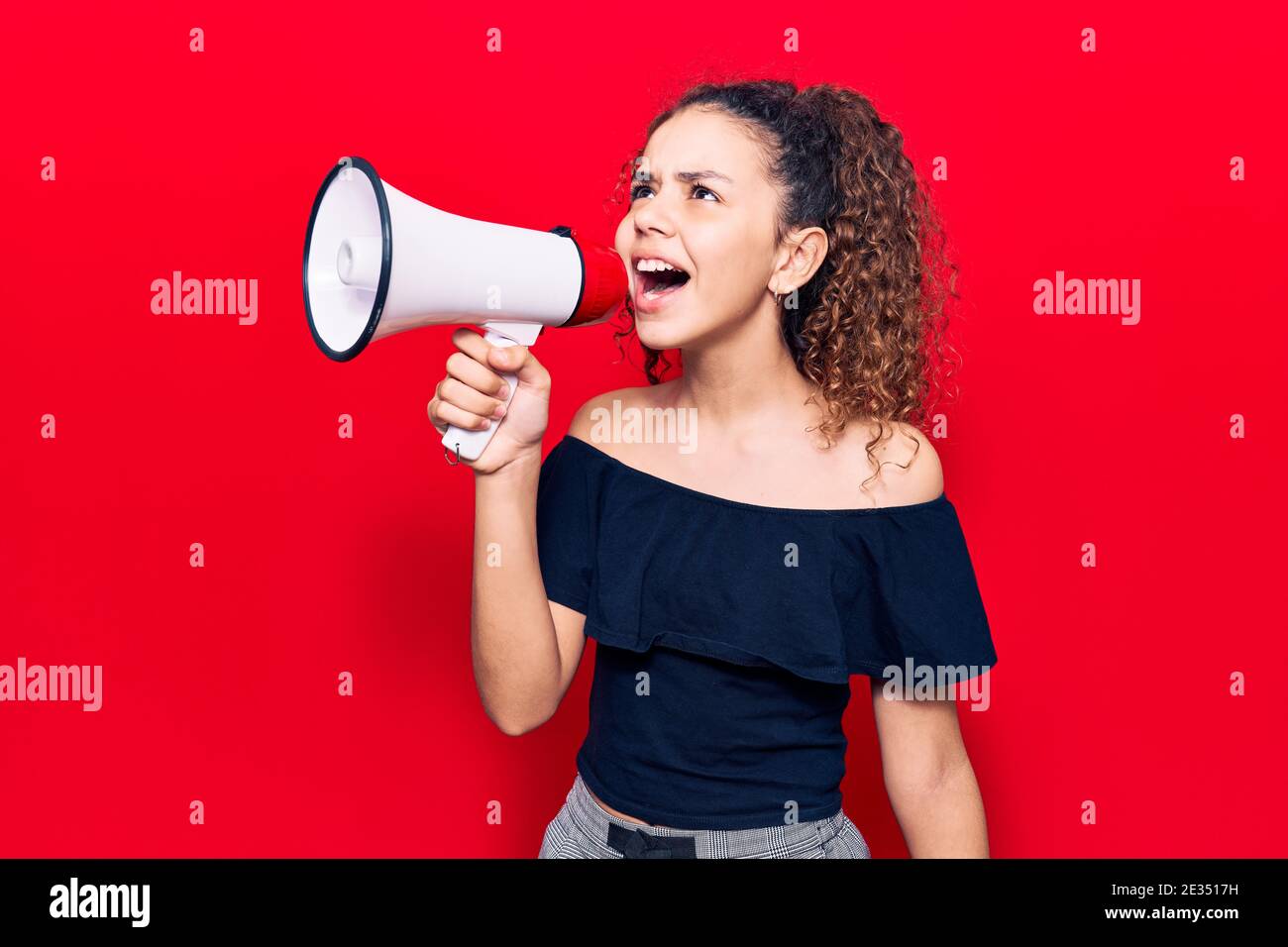 Adorable latin teenager girl with angry expression. Screaming loud ...