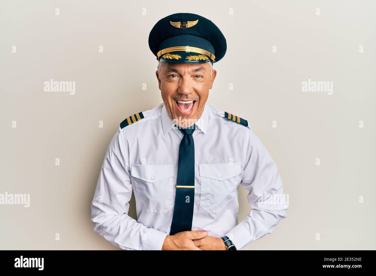 Handsome middle age mature man wearing airplane pilot uniform smiling ...