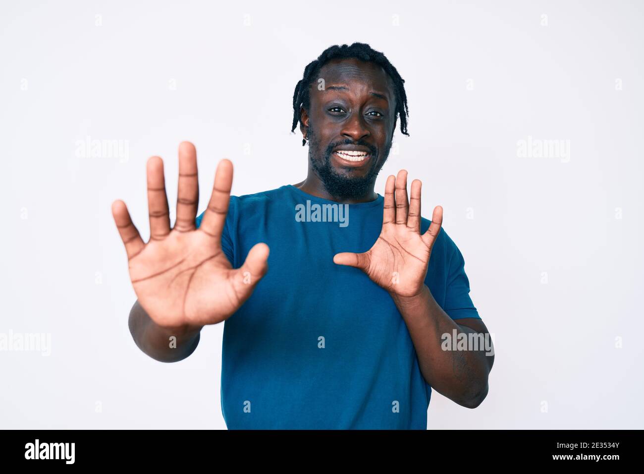 Young african american man with braids wearing casual clothes afraid ...