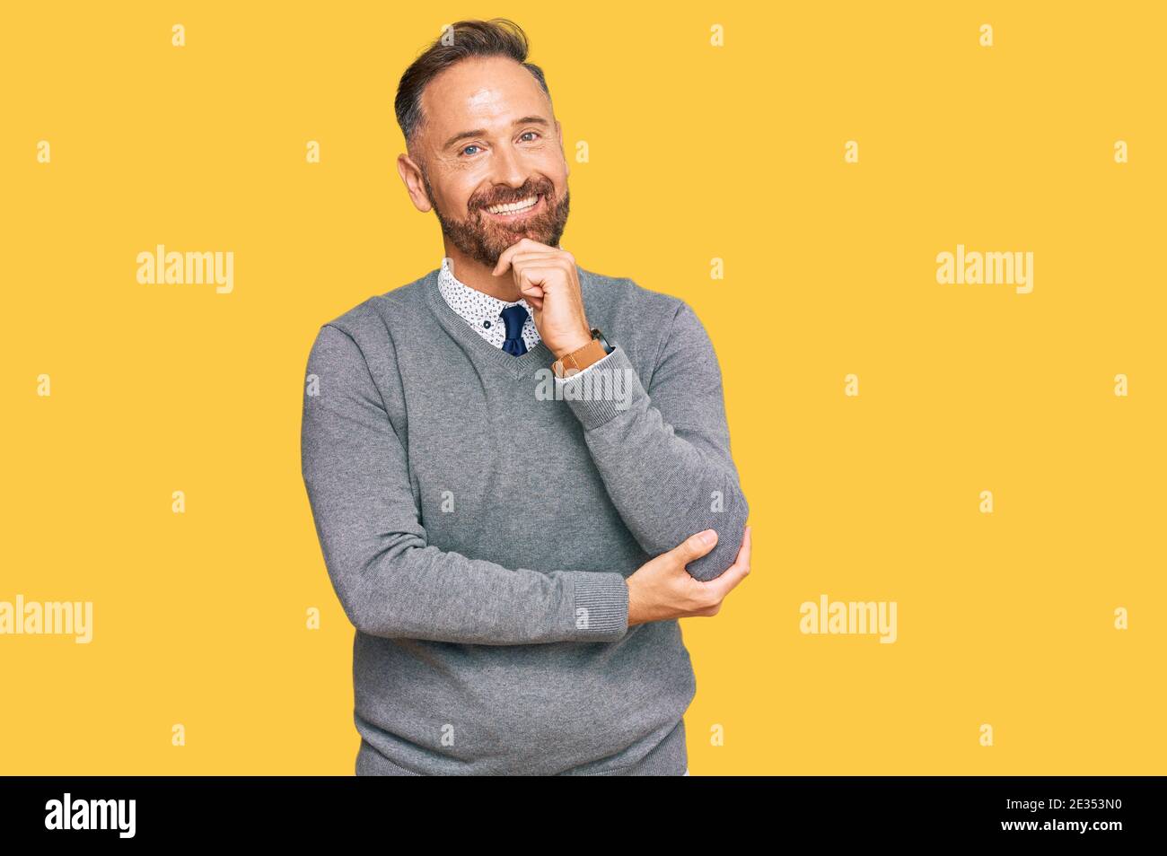 Handsome middle age man wearing business clothes looking confident at ...